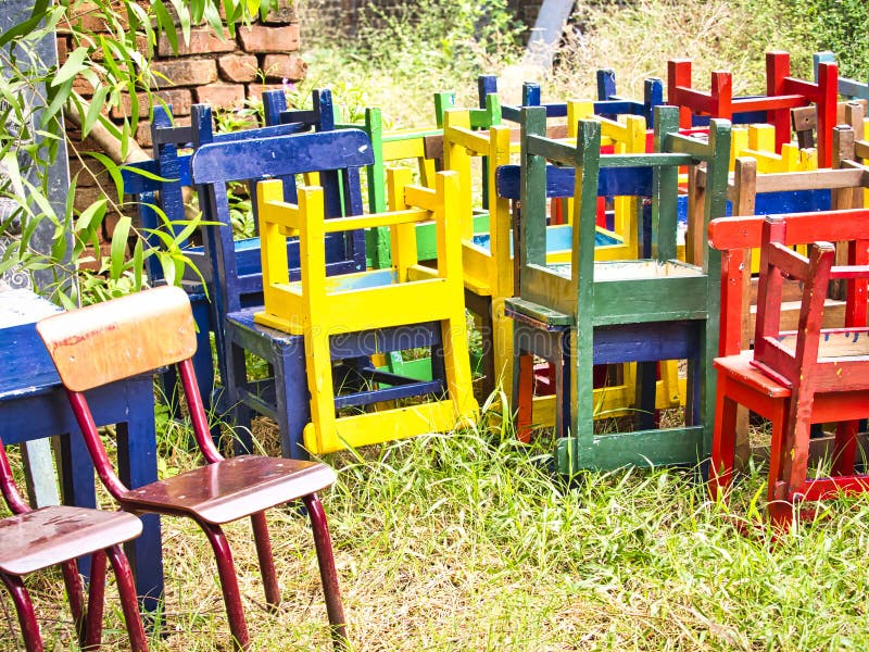 Stack of Assorted Colored Wooden Chairs in Random Disarray, Full Frame ...