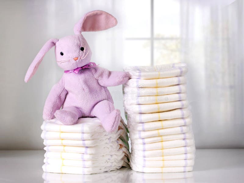Toy Bunny Sitting on Stack of Disposable Diapers or Nappies,Stack of ...