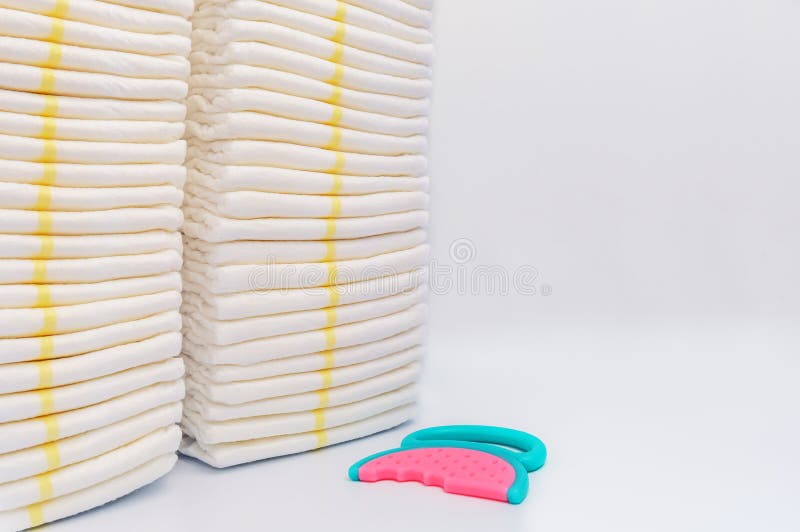 Stack of Baby Disposable Diapers and Pacifier Over White Background ...