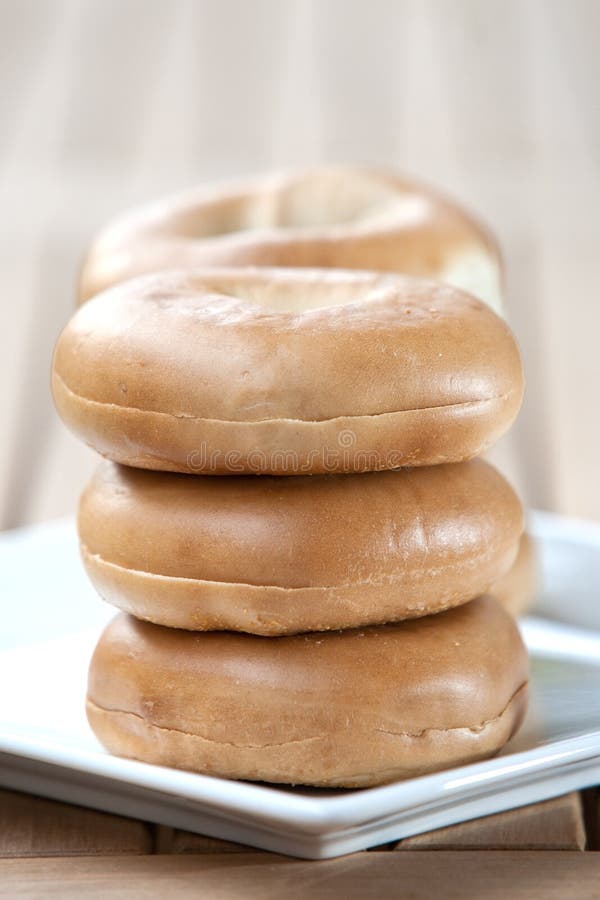 Stack of Bagel on White Plate Stock Image - Image of snack, delicious ...