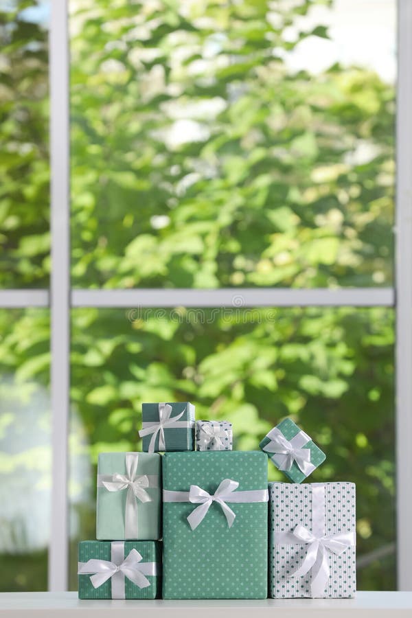 Stack of Beautifully Wrapped Gift Boxes on White Table Near Window ...