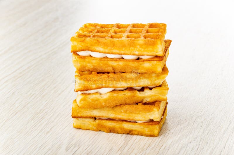 Stack of Biscuit Waffles with Cream on Wooden Table Stock Image - Image ...