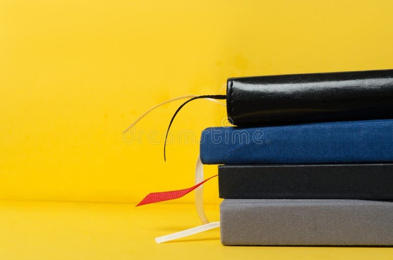 Stack of Black,gray and Blue Notebooks with Bookmarks on the Bright ...