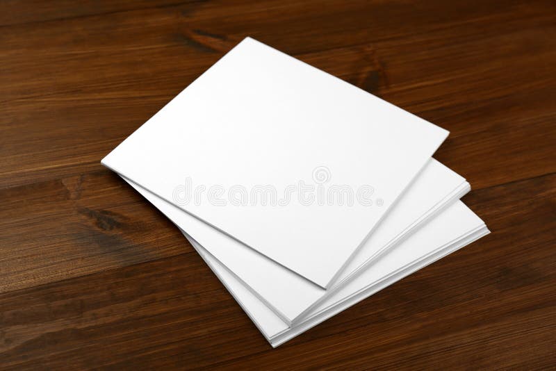 Stack of Blank Paper Sheets on Wooden Table. Brochure Design Stock ...