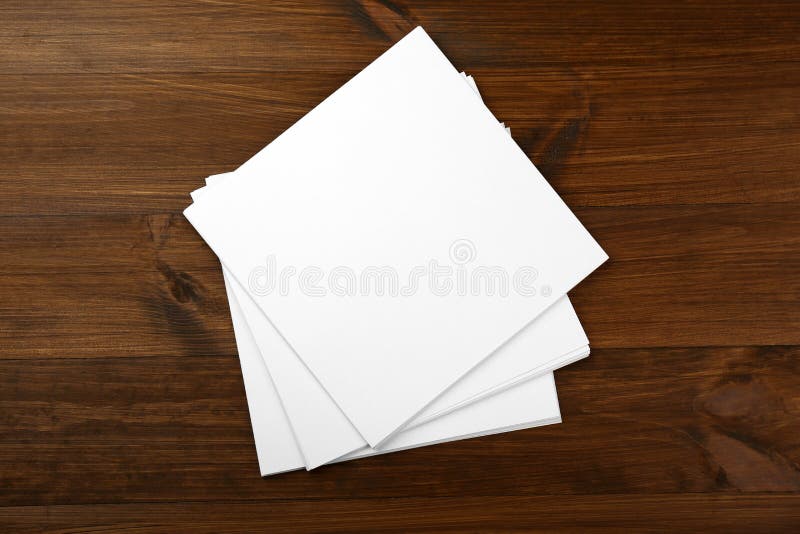 Stack of Blank Paper Sheets on Wooden Table. Brochure Design Stock ...