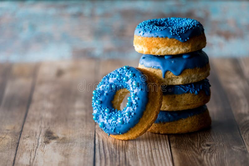 A Stack of Blue Decorated Donuts with One Leaning in Front. Stock Photo ...