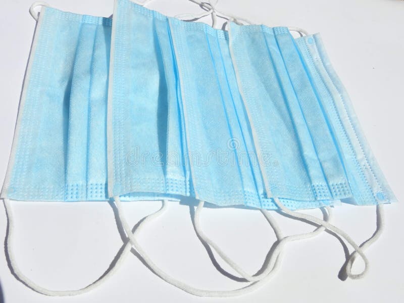 Stack of Blue Surgical Face Masks Laying on White Background Stock ...