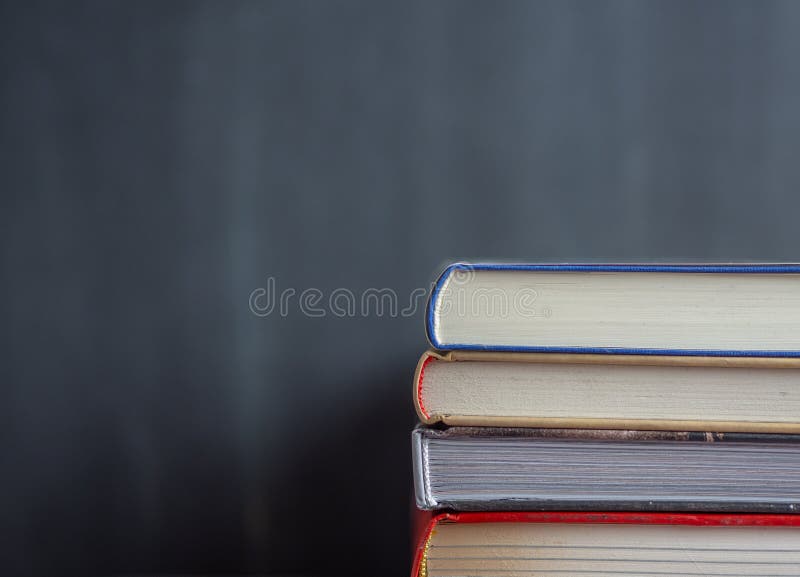 Stack of Book Resting in Front of a Chalkboard Stock Image - Image of ...