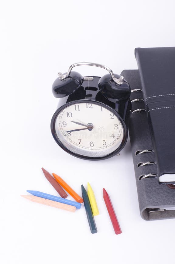 Stack of Book with Ticking Vintage Clock and Colorful Crayon on White ...