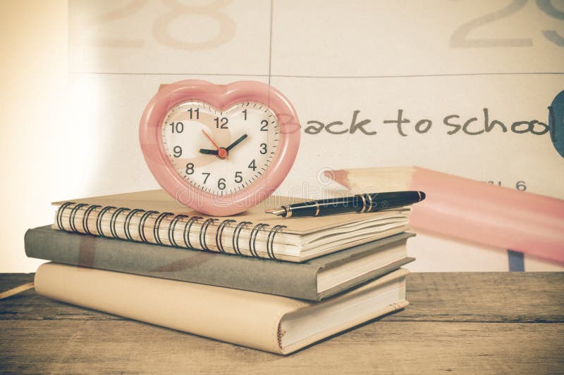 Stack of Books and an Alarm Clock on Wood Stock Image - Image of book ...