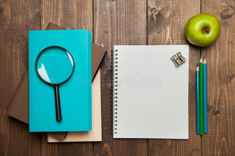 Stack of Books, Apple, Magnifier and Blank on Wood Stock Photo - Image ...
