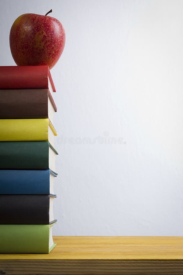 Stack of books and apple stock photo. Image of objects - 163868590