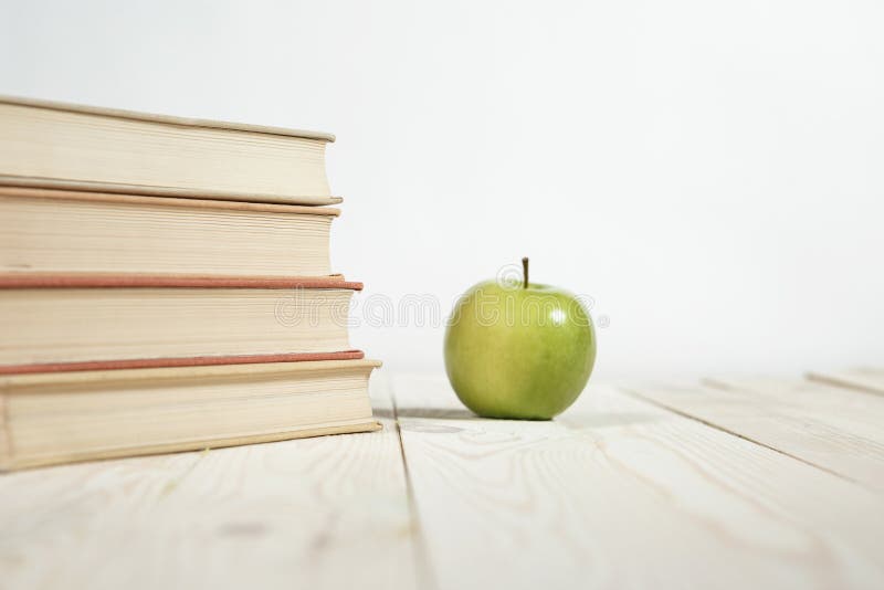 Stack of Books and Apple on the Table Stock Photo - Image of apple ...