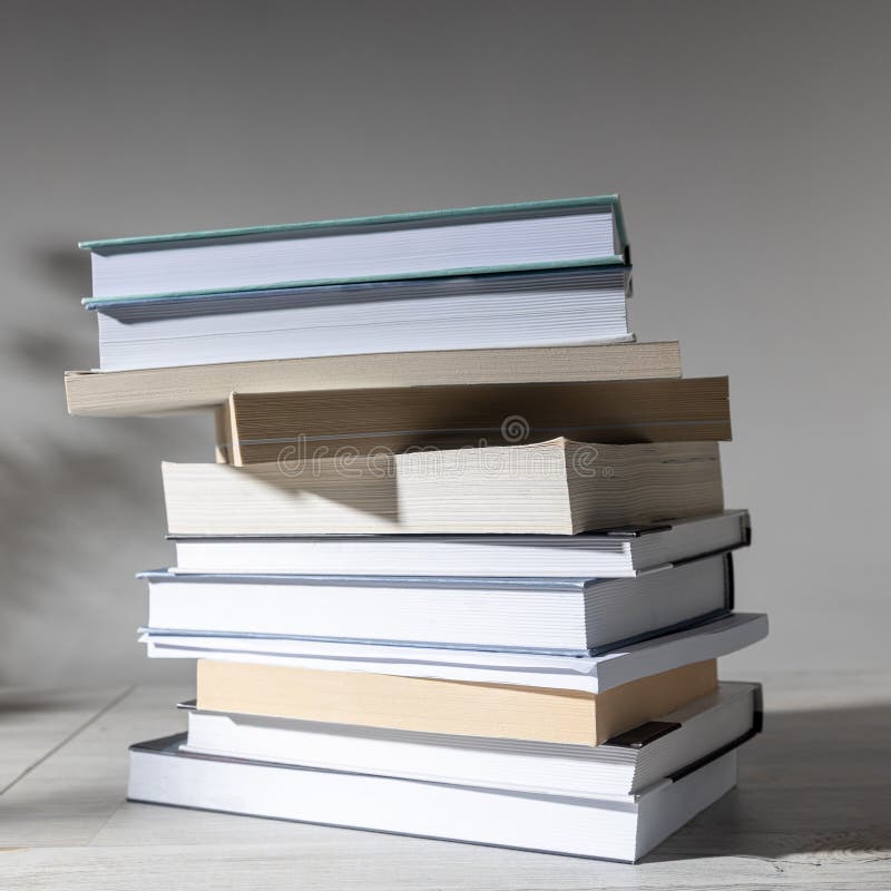 A Stack of Books are on a Beige Table Against White Wall. Scandinavian ...
