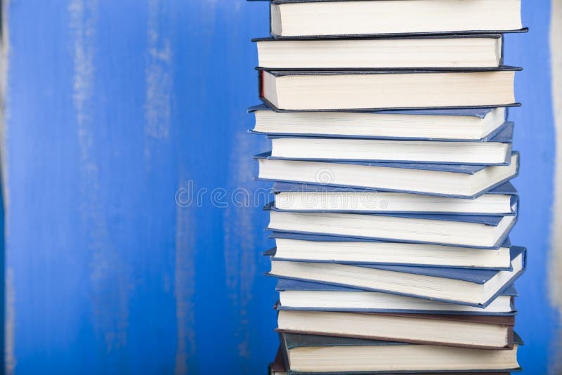 Stack of Books on a Blue Background. Stock Image - Image of back ...