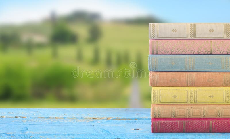 Stack of Books on Blurred Nature Background, Stock Photo - Image of ...