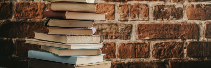 Stack of Books in the Colored Cover Lay on the Wood Table with Brick ...