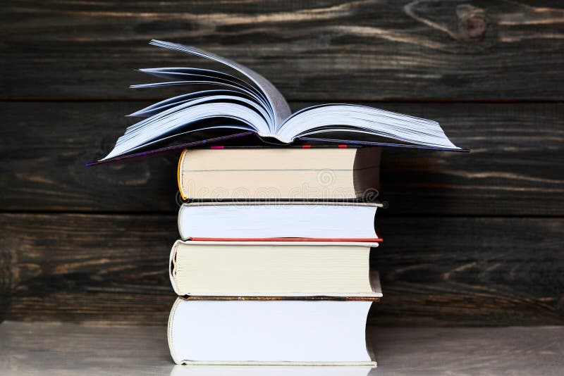 Stack of Books with Dark Wooden Background. One Book is Opened Stock ...