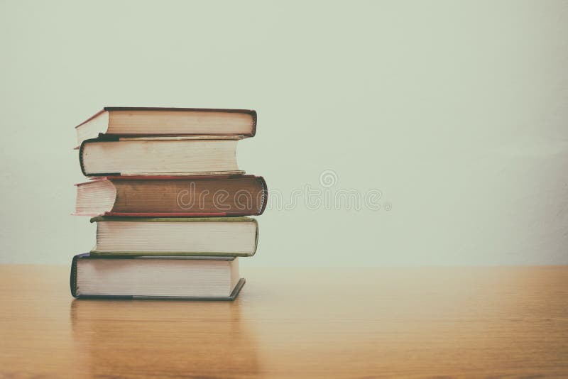 Stack of Books on Desk with Vintage Filter Blur Background Stock Photo ...
