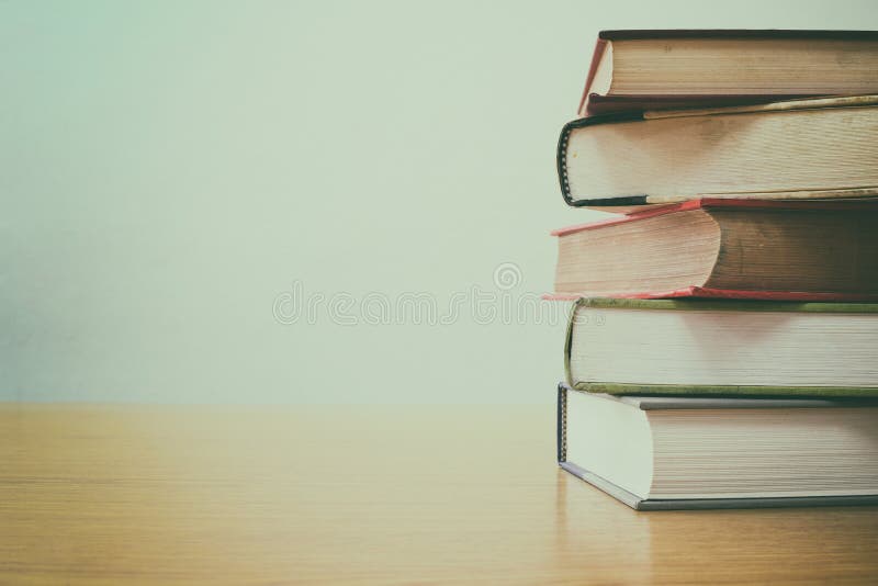 Stack of Books on Desk with Vintage Filter Blur Background Stock Photo ...