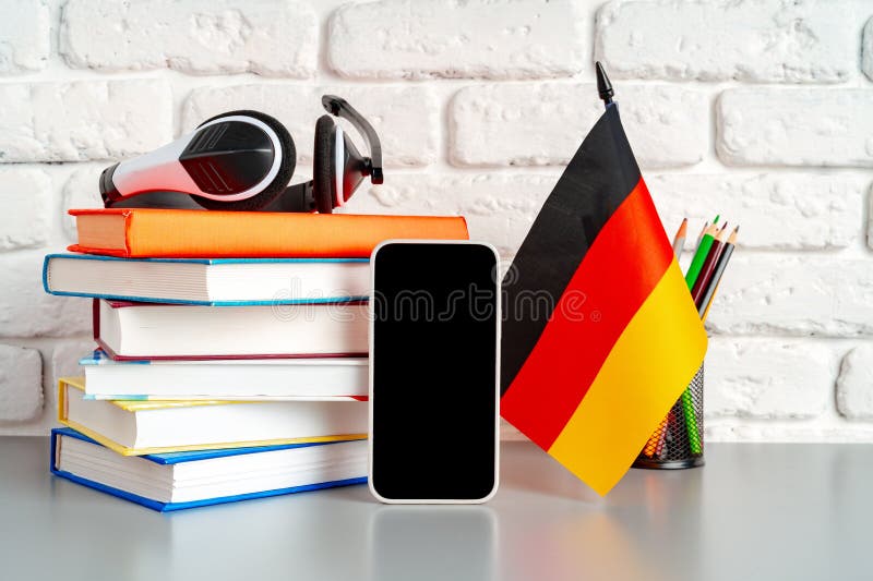 Stack of Books and Flag of Germany on Desk. German Language Learning ...