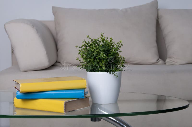 Stack Books on a Glass Table Against the Background of the Sofa Stock ...