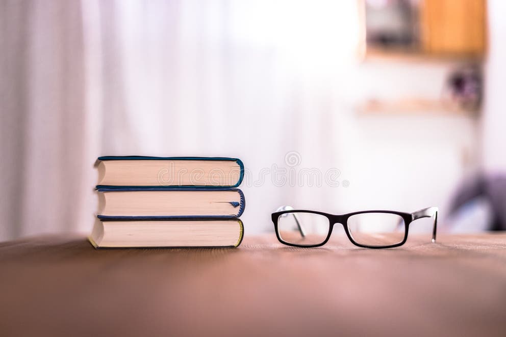 Knowledge and Science Concept: Stack of Books and Glasses Lying on ...