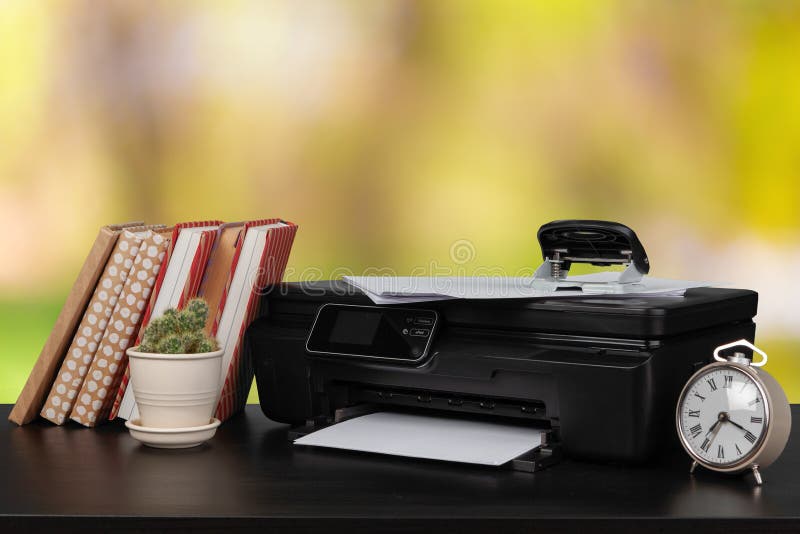 Stack of Books and Home Printer Against Blurred Background Stock Photo ...