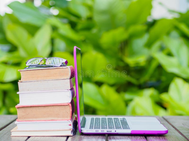 Stack of Books with Laptop on Wood Table Stock Image - Image of ...