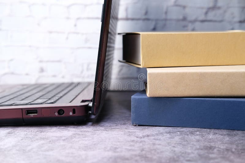 Stack of Books with Laptop on Wooden Table. Stock Photo - Image of ...