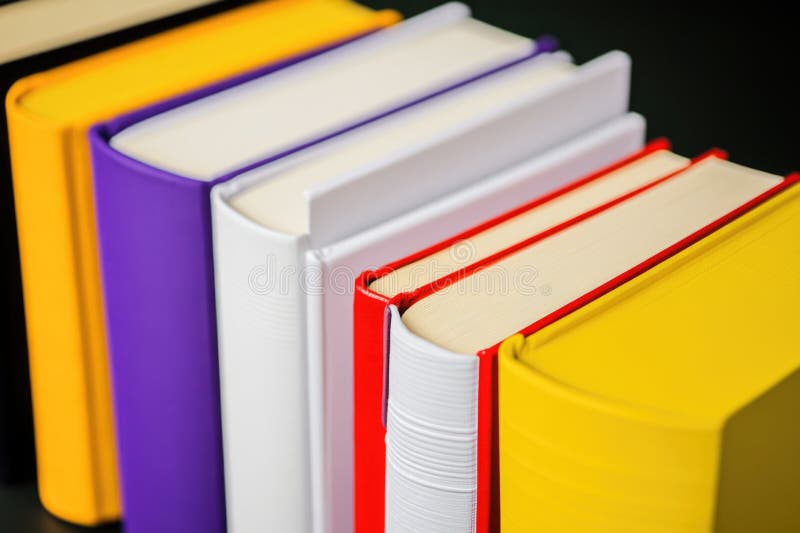 A Stack of Books Lined Up Side by Side Stock Photo - Image of texts ...