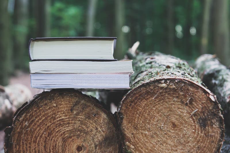 A Stack of Books Lying on Felled Trees, Save Trees - Read Ebook Stock ...
