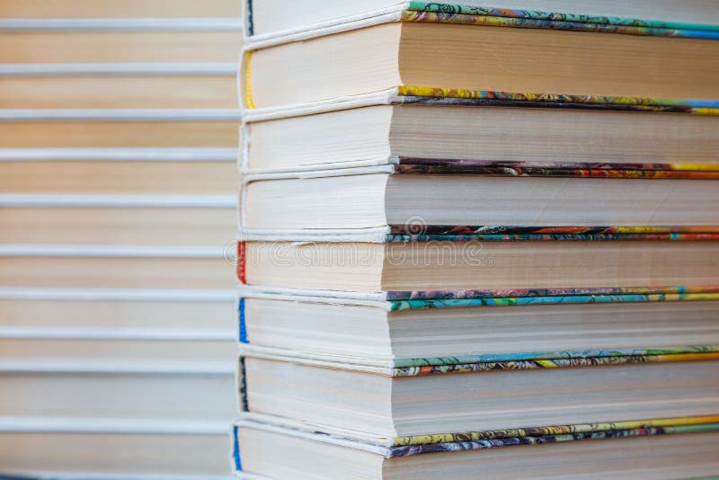 A Stack of Books in Multicolored Covers in the Library or Bookstore ...