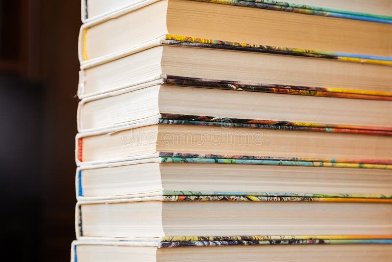 A Stack of Books in Multicolored Covers in the Library or Bookstore ...