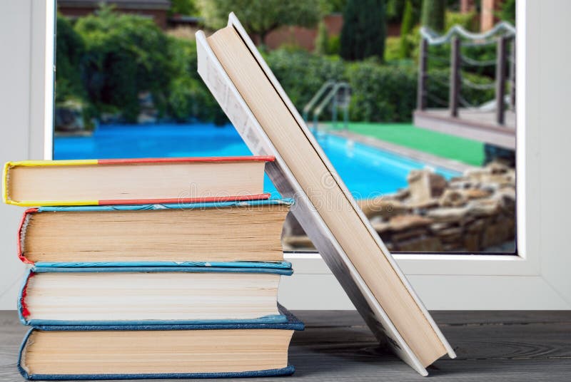 A Stack of Books Near the Window and a Pool in the Background Stock ...
