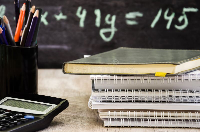 A Stack of Books, Notebooks, Pens and Writing Instruments Against a ...