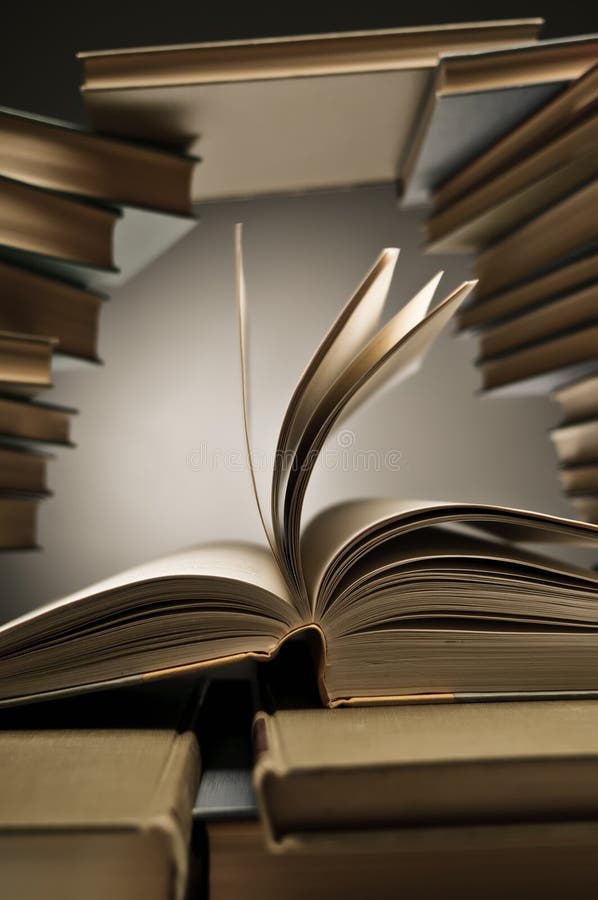 Stack of Books with One Open among Them Stock Image - Image of vertical ...