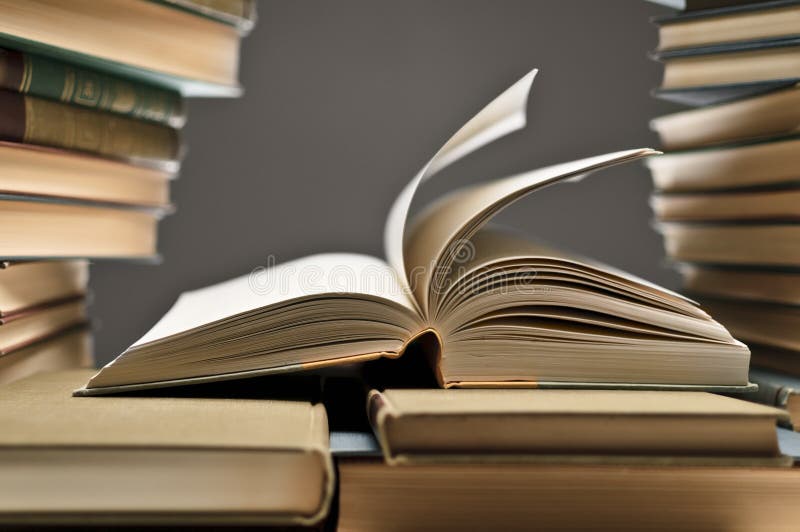 Stack of Books with One Open among Them Stock Image - Image of backlit ...