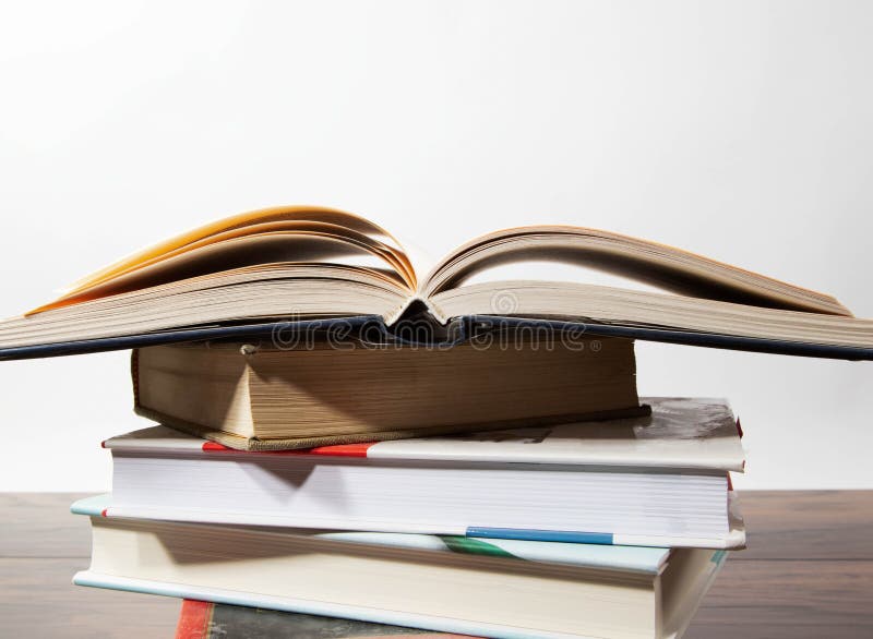 Stack of Books with One Open on Top of Stack Stock Image - Image of ...