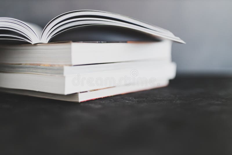 Stack of Books with One Open on Top of Themshot from Eye Level with ...