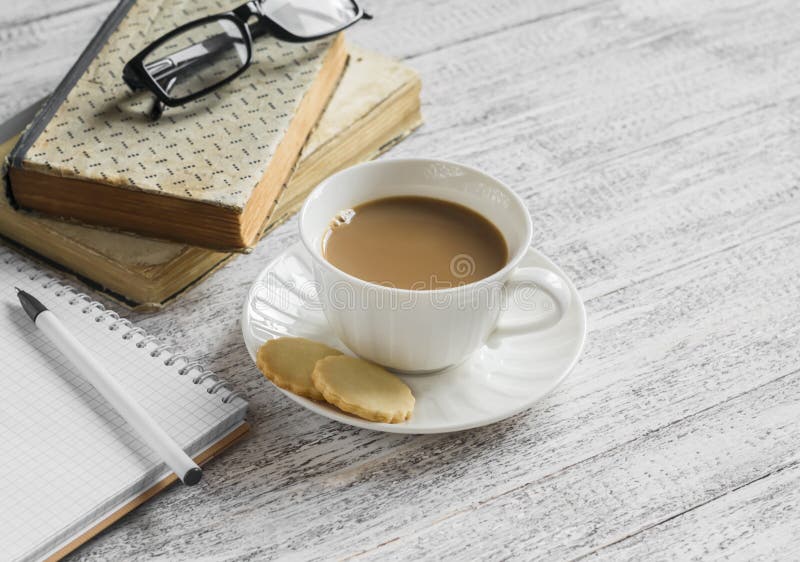 A Stack of Books, Open Clean Notepad, Glasses and a Cup of Cocoa on a ...