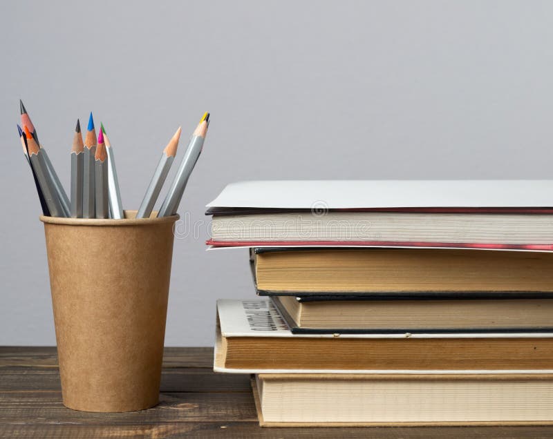 Stack of Books and a Pencil Holder on a Table Stock Photo - Image of ...