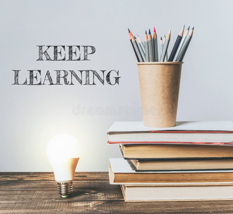 A Stack of Books with a Pencil Holder on Top Stock Image - Image of ...