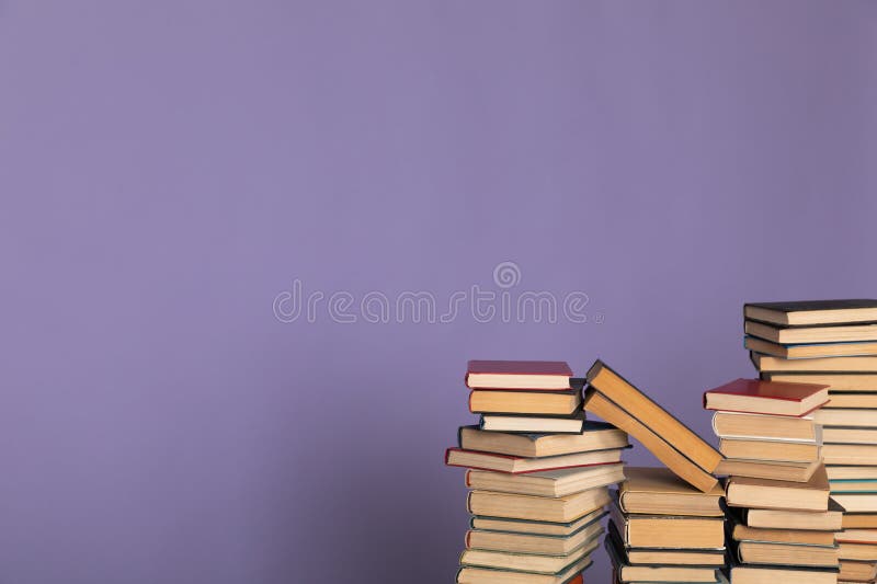A Stack of Books on a Purple Background in the Library in the Office ...