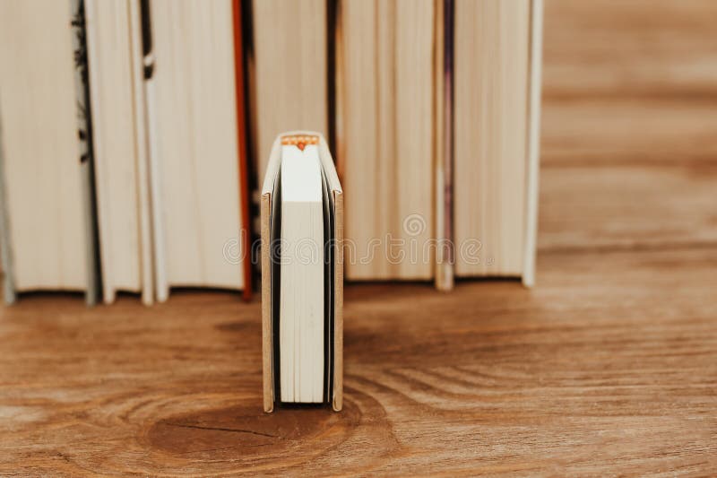 A Stack of Books Stand on the Tables, Stacked in the Frame, Next To ...
