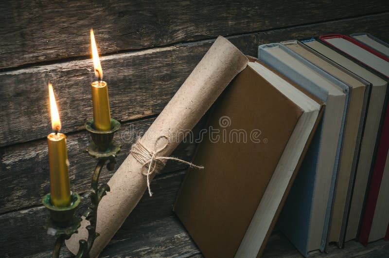 Books and burning candle. stock photo. Image of artist - 125277082