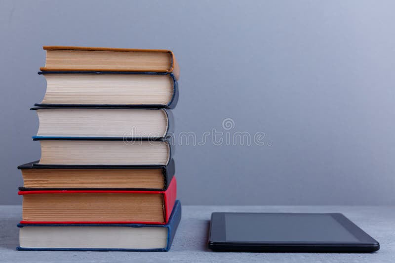 A Stack of Books and a Tablet Next. the Concept of Education ...