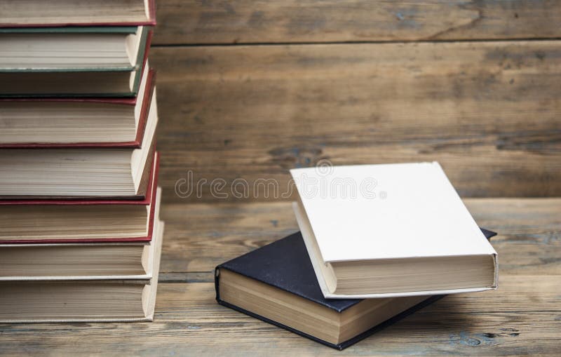 Stack of Books on Wooden Table Over Rustic Background with Copy Space ...