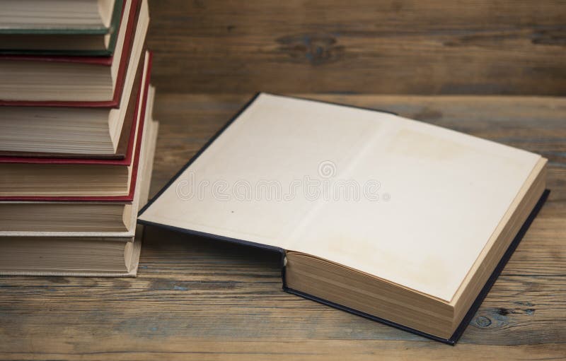 Stack of Books on Wooden Table Over Rustic Background with Copy Space ...