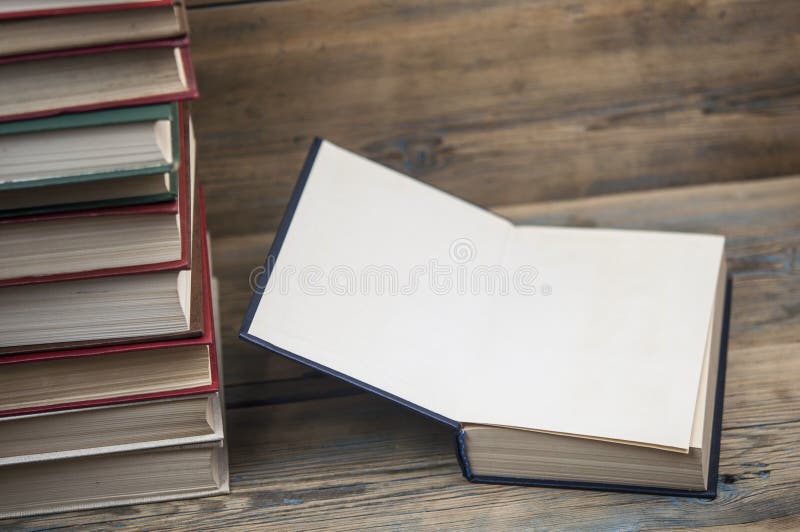 Stack of Books on Wooden Table Over Rustic Background with Copy Space ...